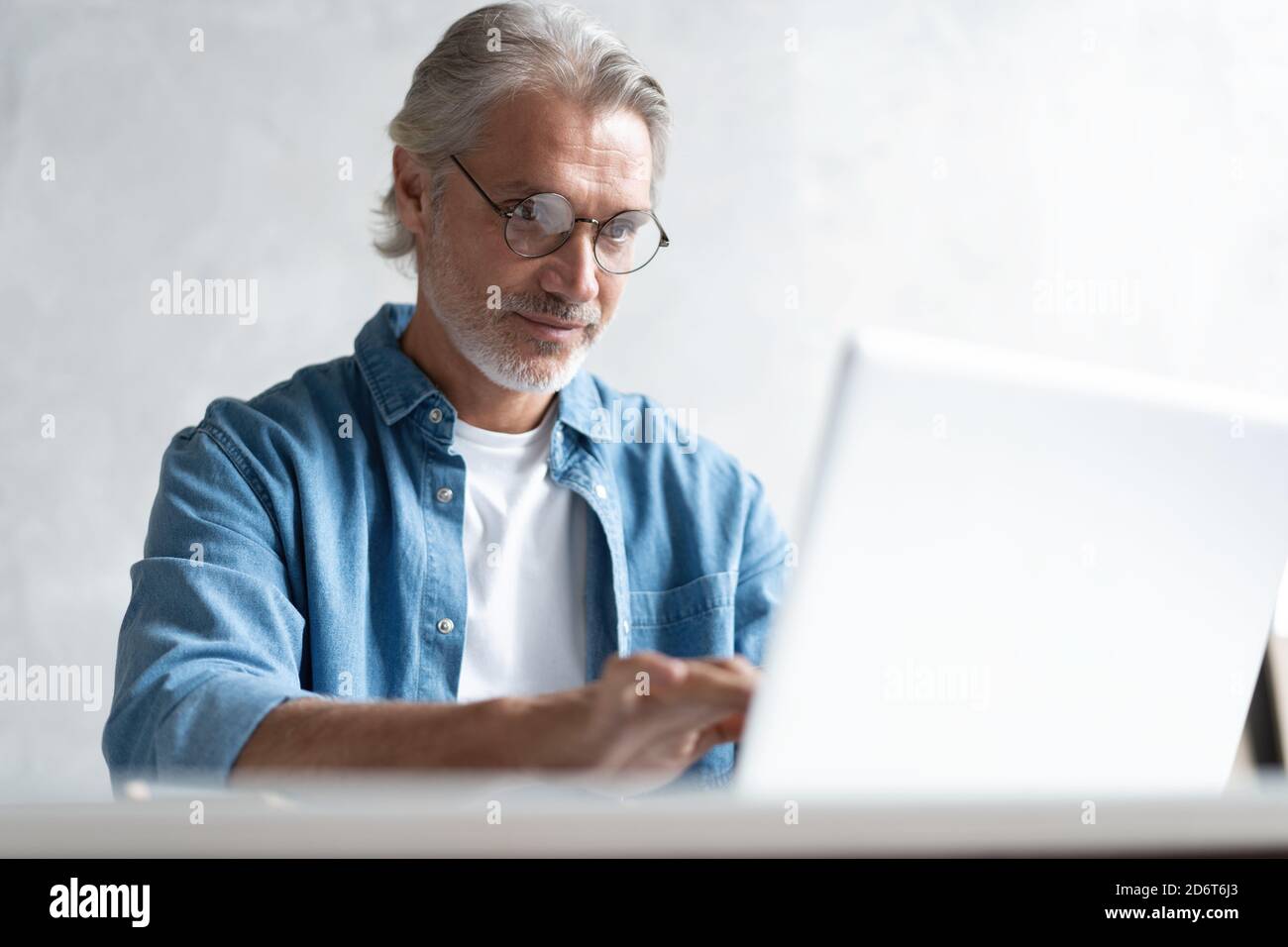 Middle-aged man working from home-office on laptop Stock Photo - Alamy
