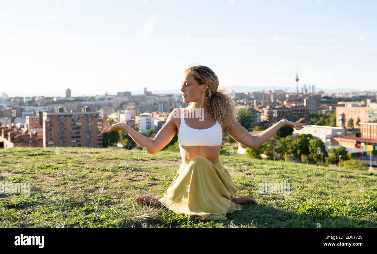 Full body sporty Woman in legging and sports bra sitting on knees on ...