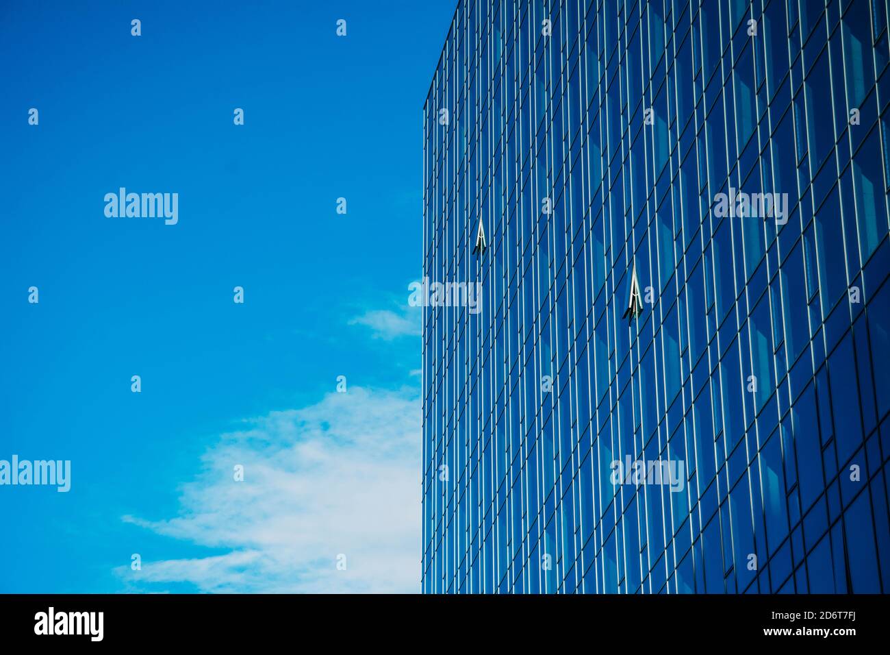 Glass office building in a city. Two windows open to let fresh air in ...