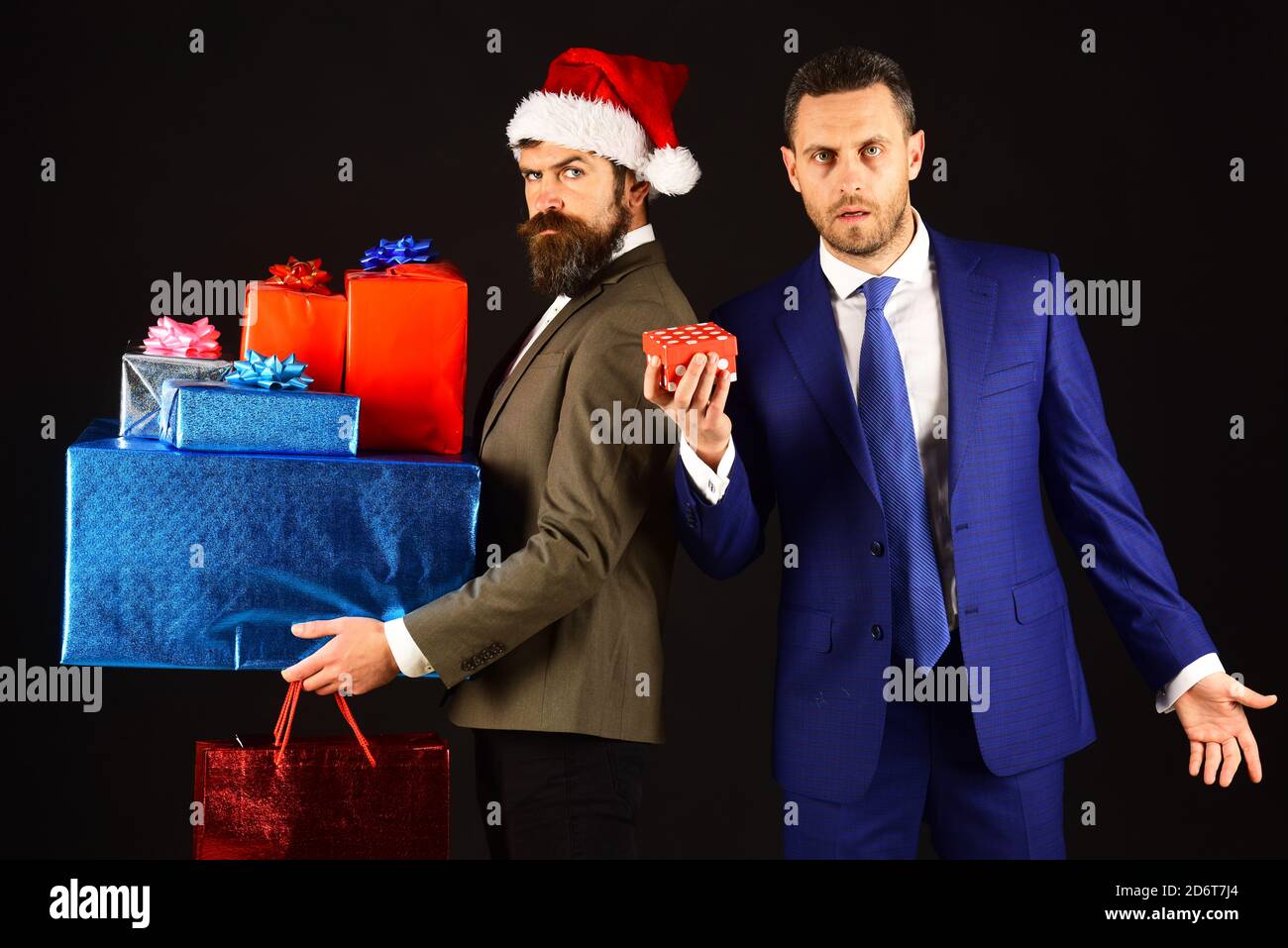 Christmas online shopping concept. Man in smart suit holding little box ...