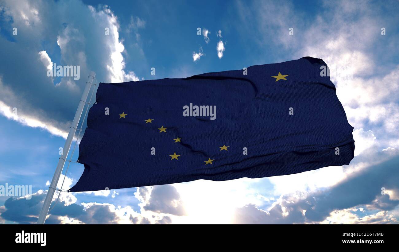 Alaska flag on a flagpole waving in the wind in the sky. State of ...