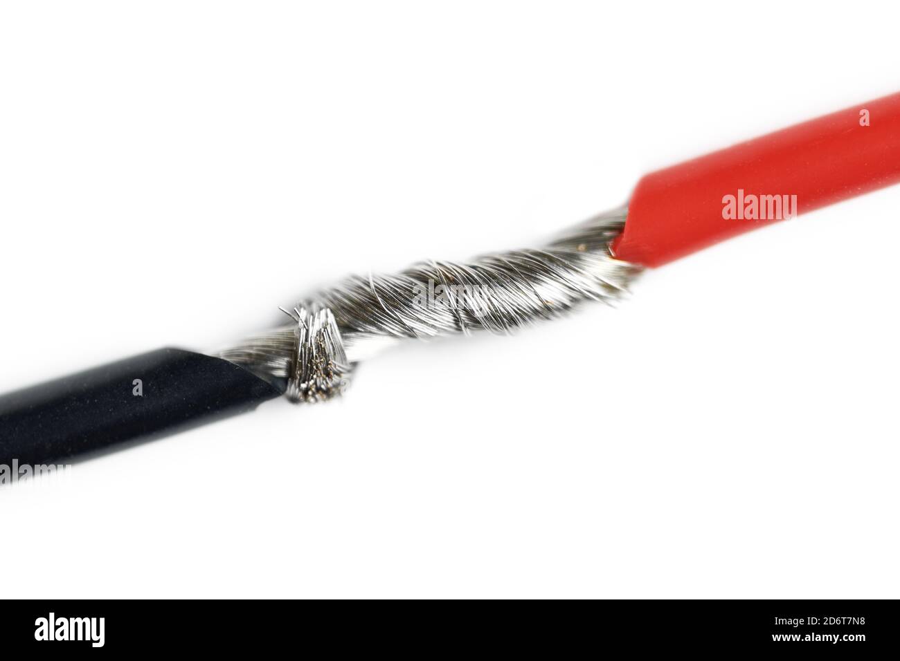 Isolated aluminum bare wires of electric cable. Red and black wires ...