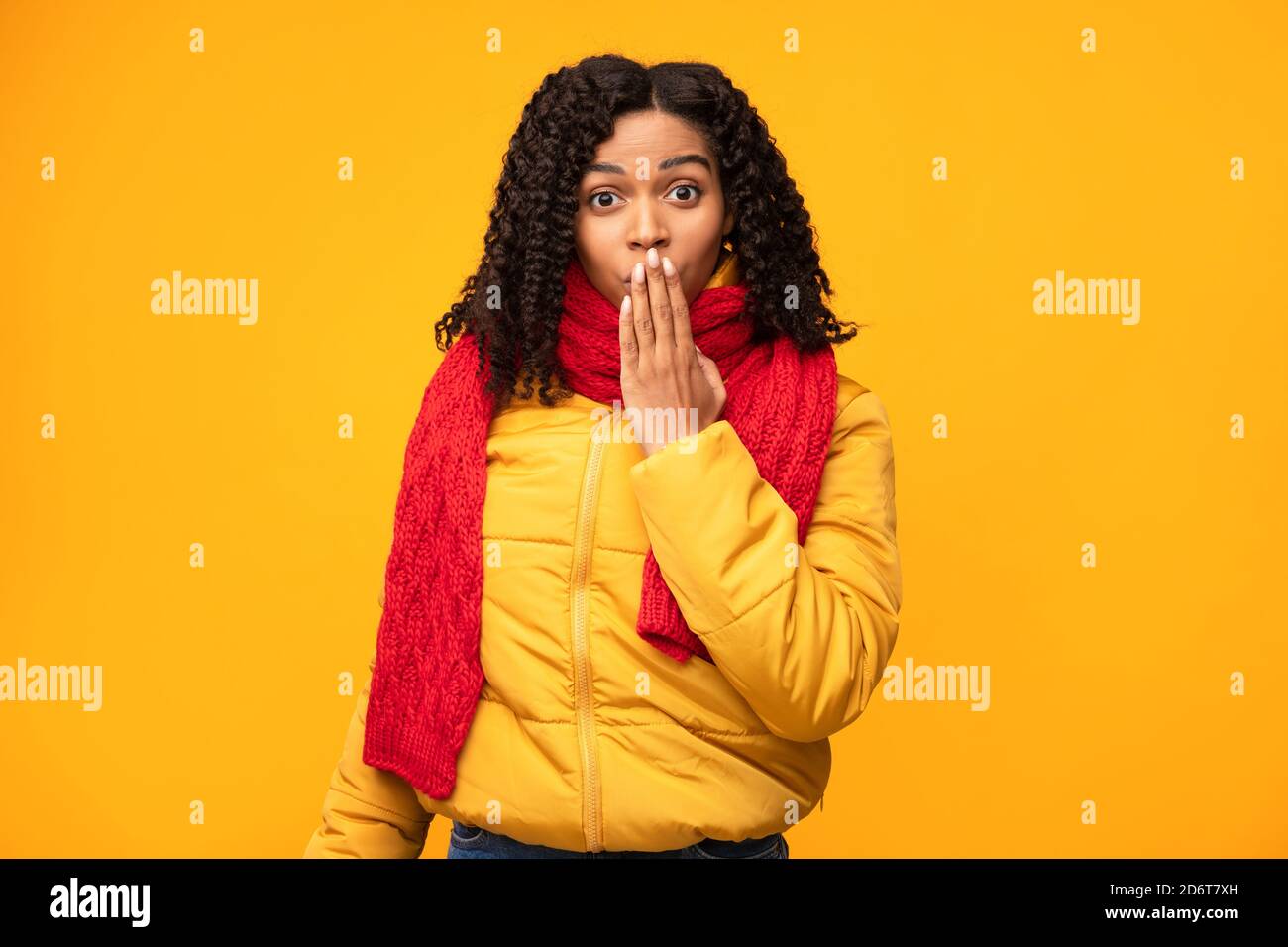African Woman Covering Mouth Posing Standing Over Yellow Studio ...