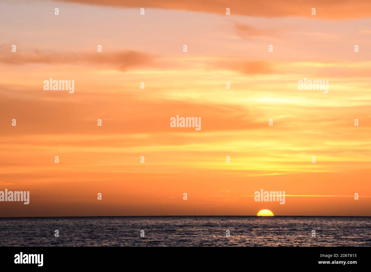 The Sun Setting in the Sea Stock Photo - Alamy