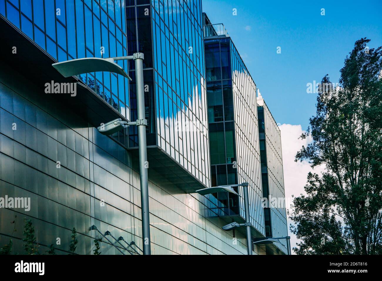 Glass office building in a city. Two windows open to let fresh air in ...
