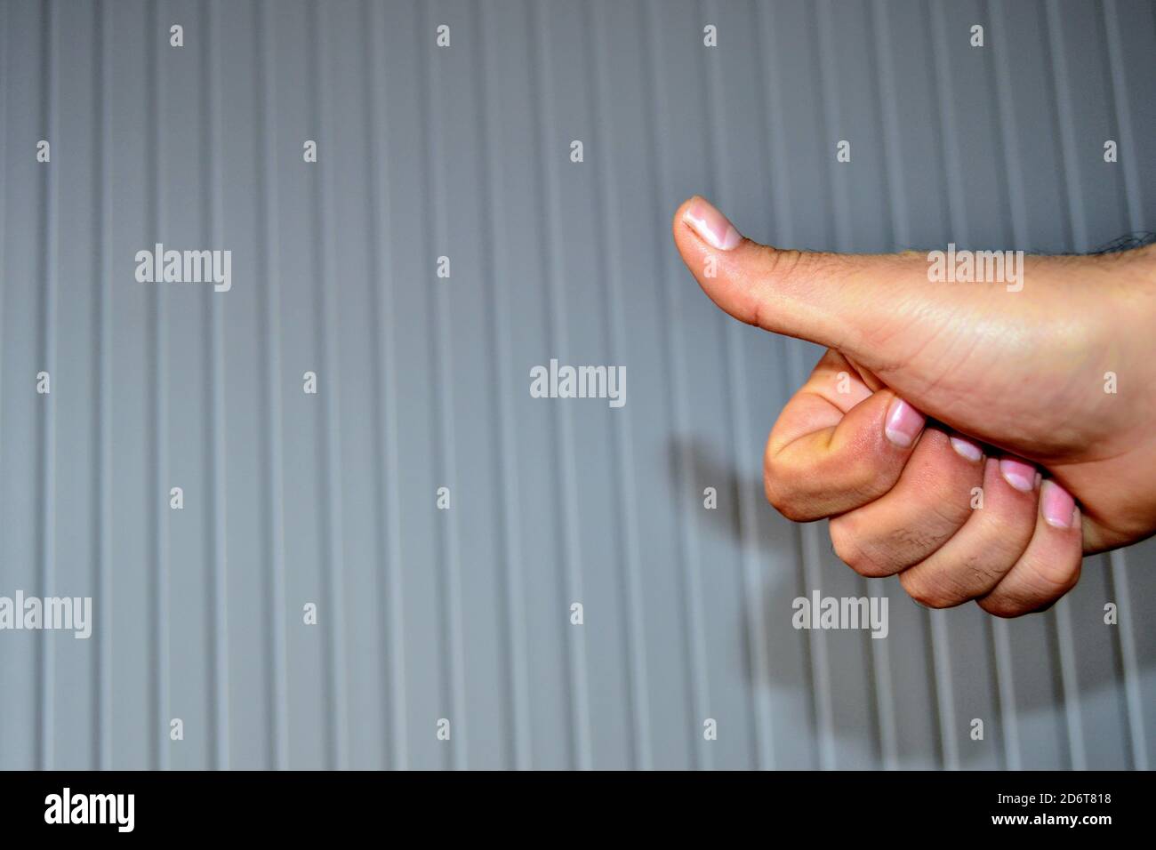 Hand and its shadow and reflection on the patterned wall of OKAY sign ...