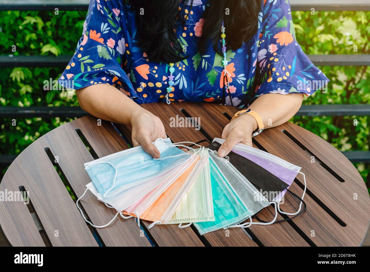 Quarantined woman choose colorful surgical masks to wear to prevent the ...