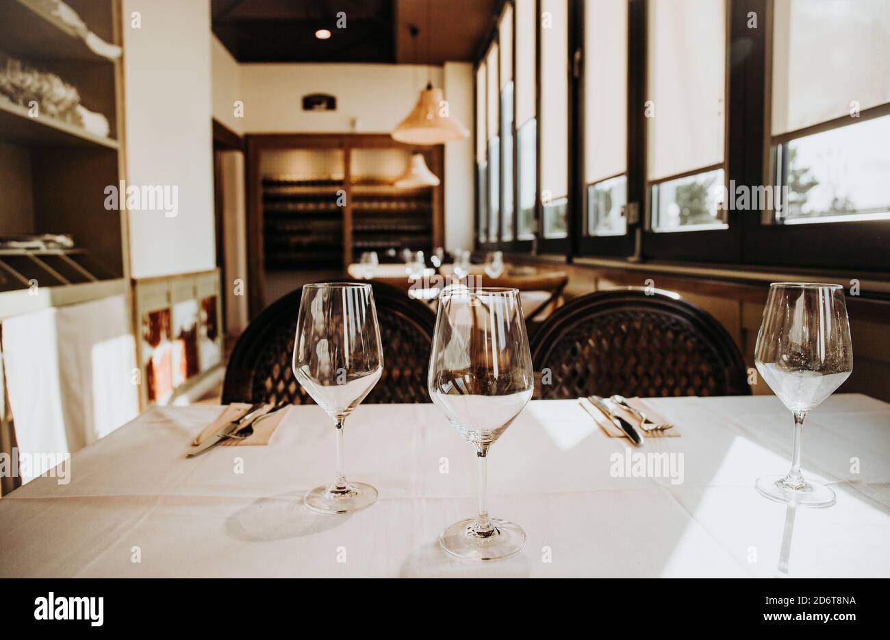 Crystal transparent goblets placed on table setting with tableware in ...