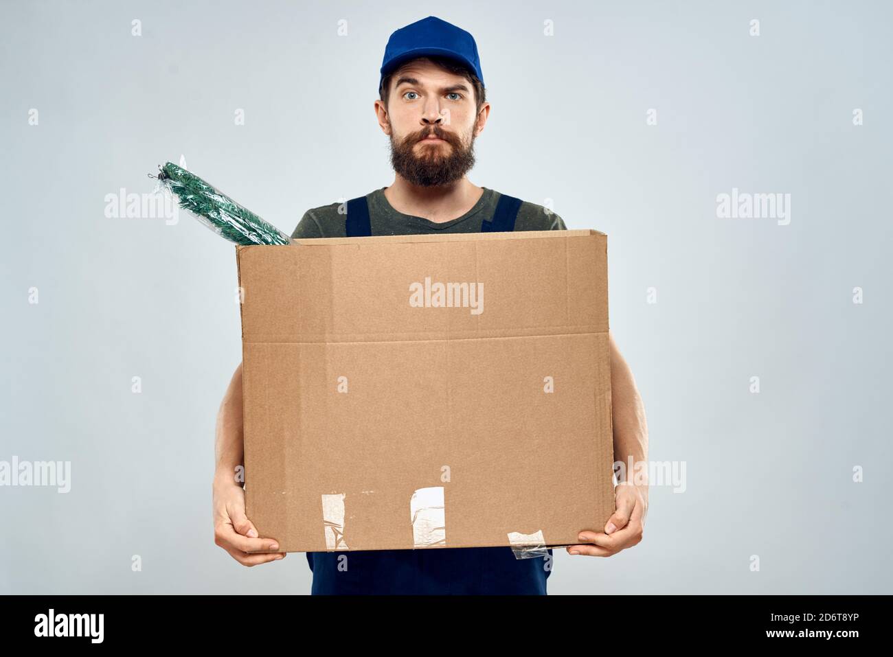 Worker man with box delivery packing work service Stock Photo - Alamy