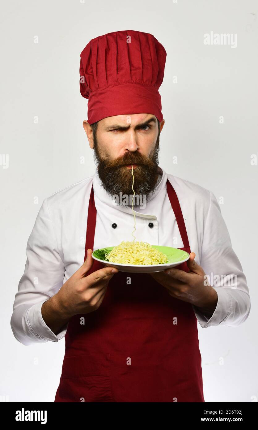 Traditional menu concept. Cook with serious face in burgundy uniform ...