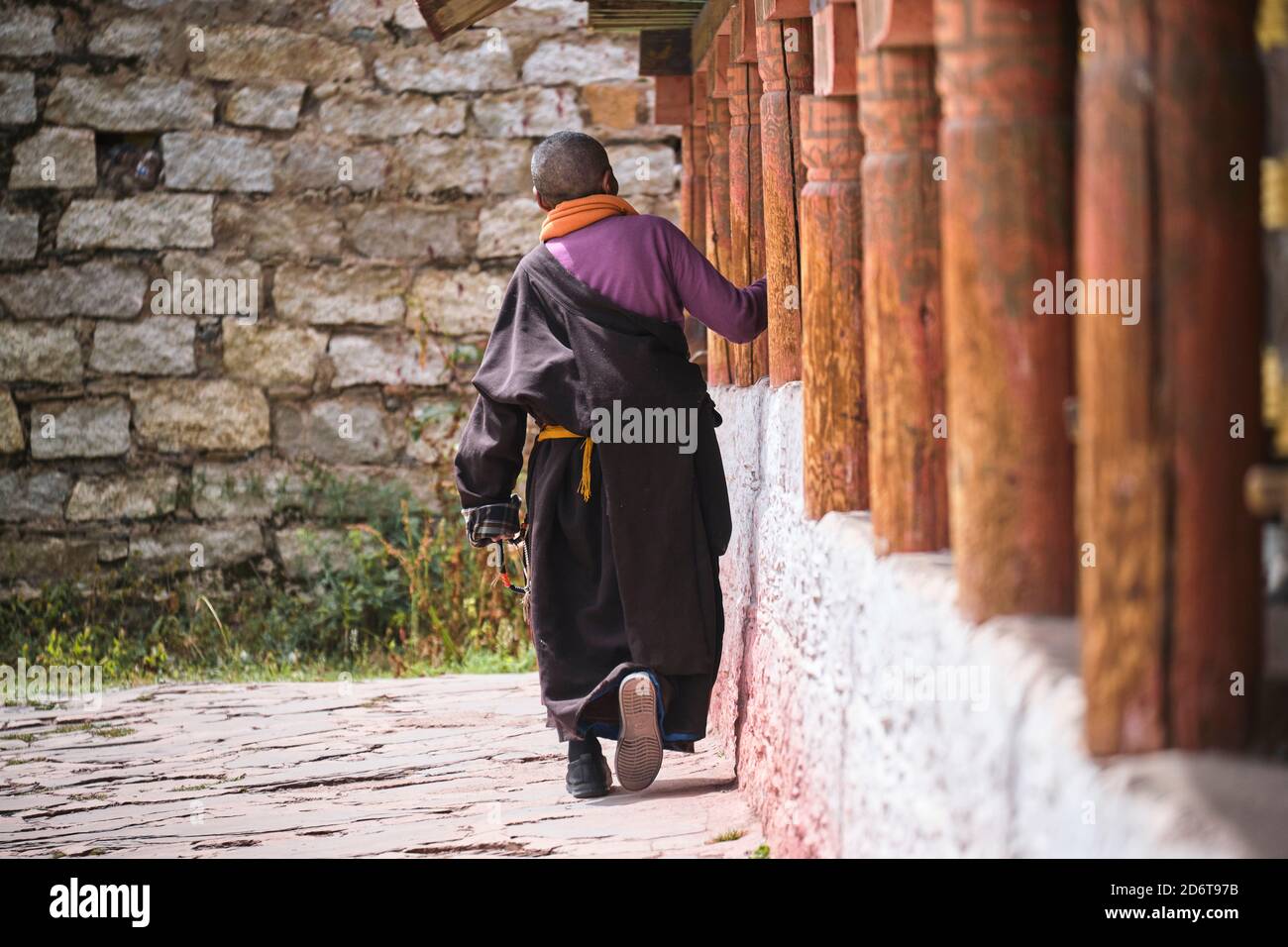 Back view of bald person in traditional colorful wearing near ancient ...