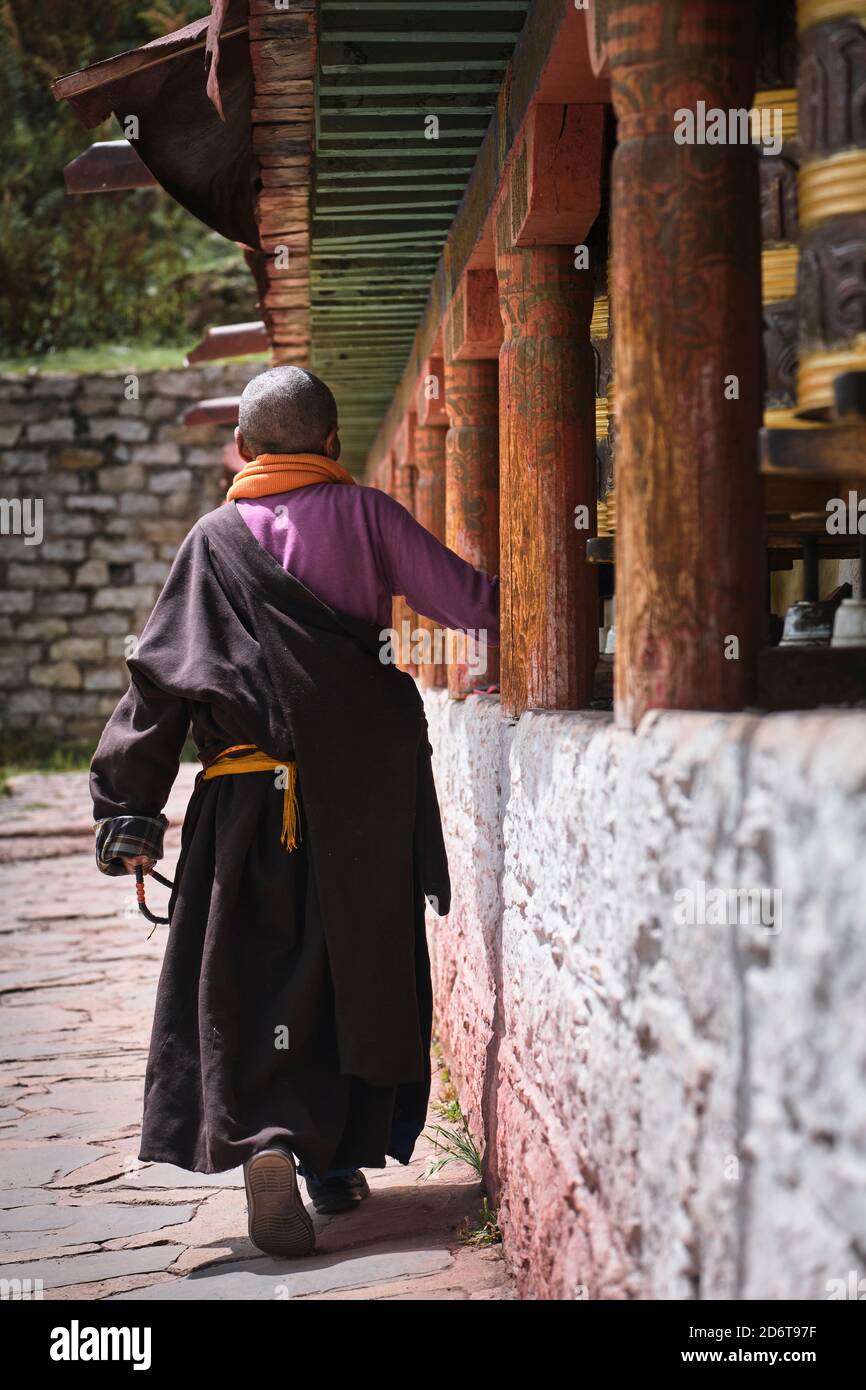 Back view of bald person in traditional colorful wearing near ancient ...