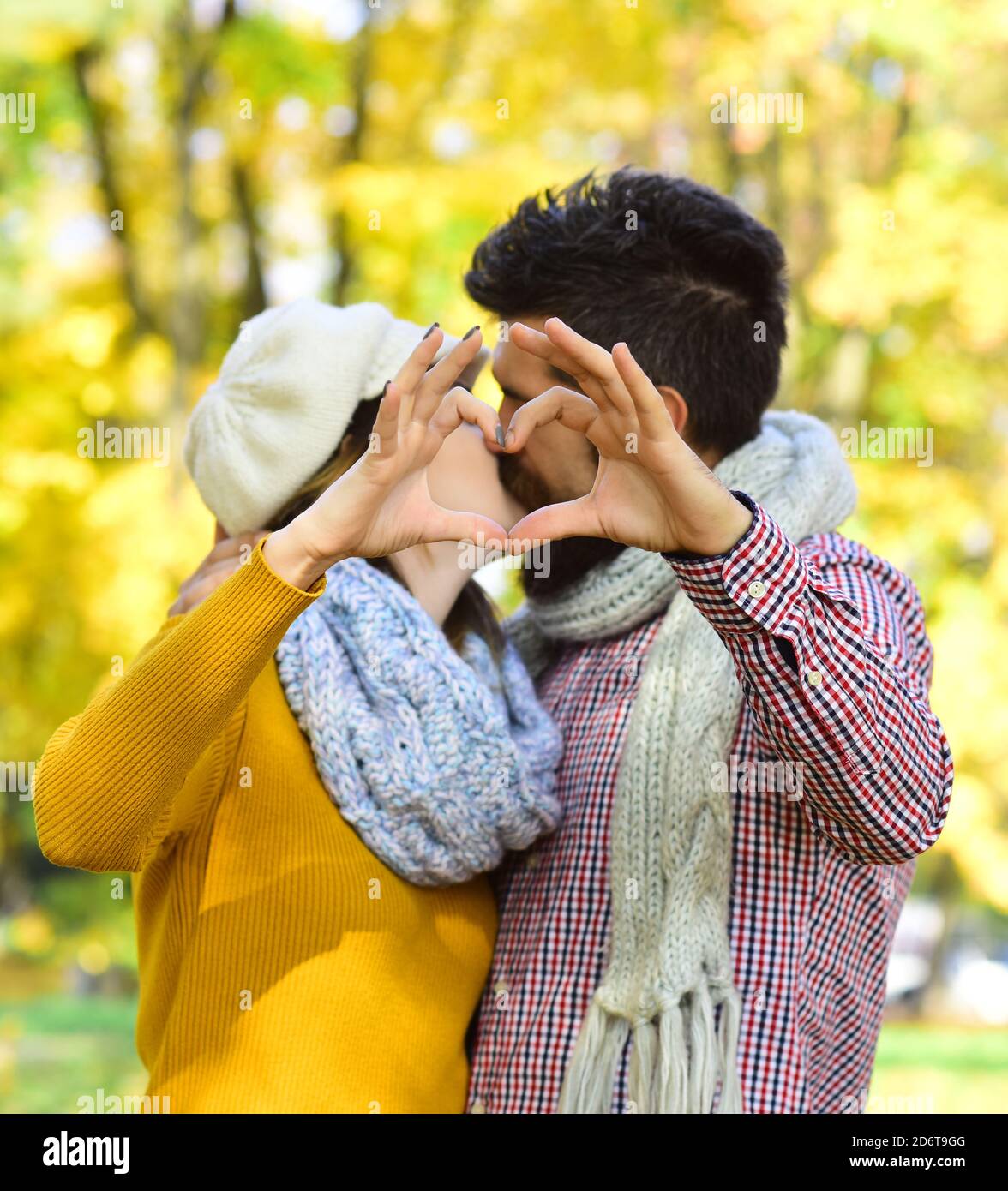 Close up of couple making heart shape with hands. Man and woman with ...