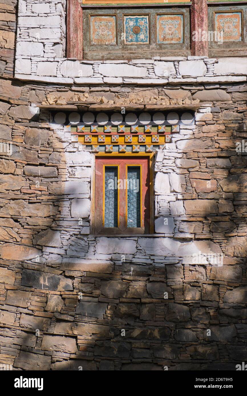 Exterior of aged stone house with weathered small window in Sichuan ...