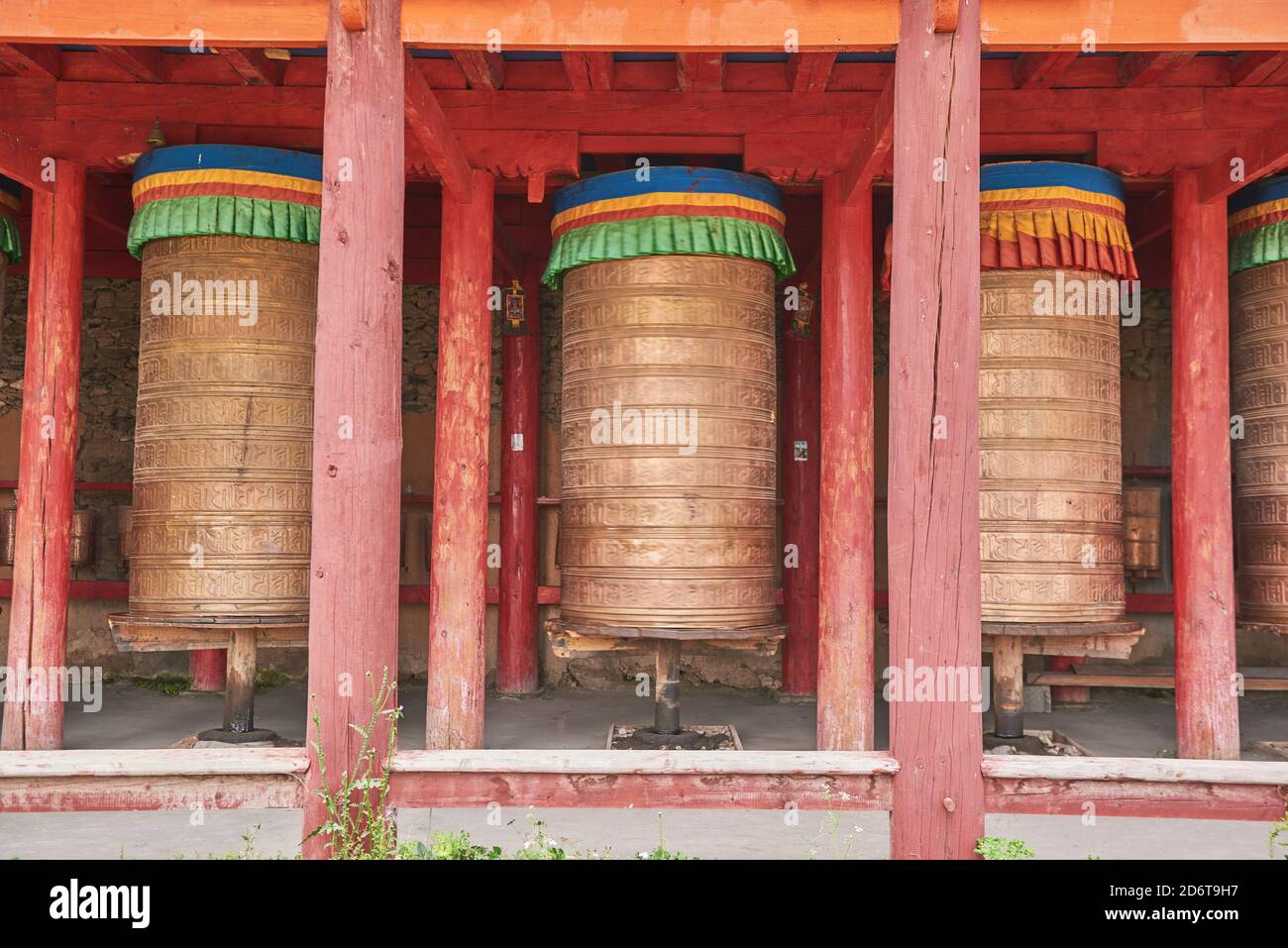 Old stone Tibetan rolls with sacred mantra consisting of sanskrit ...