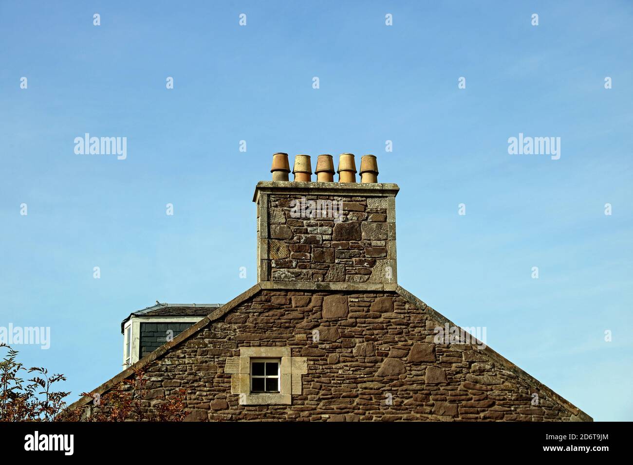 Chimney head and gable of old stone country cottage Stock Photo - Alamy