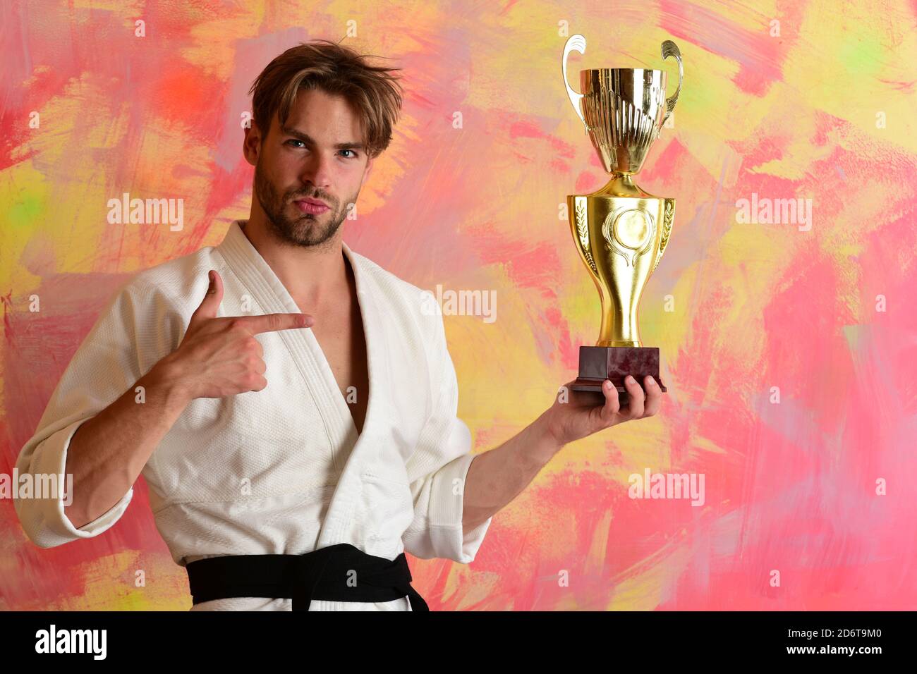 Sportive victory and award concept. Man with serious face on colorful ...