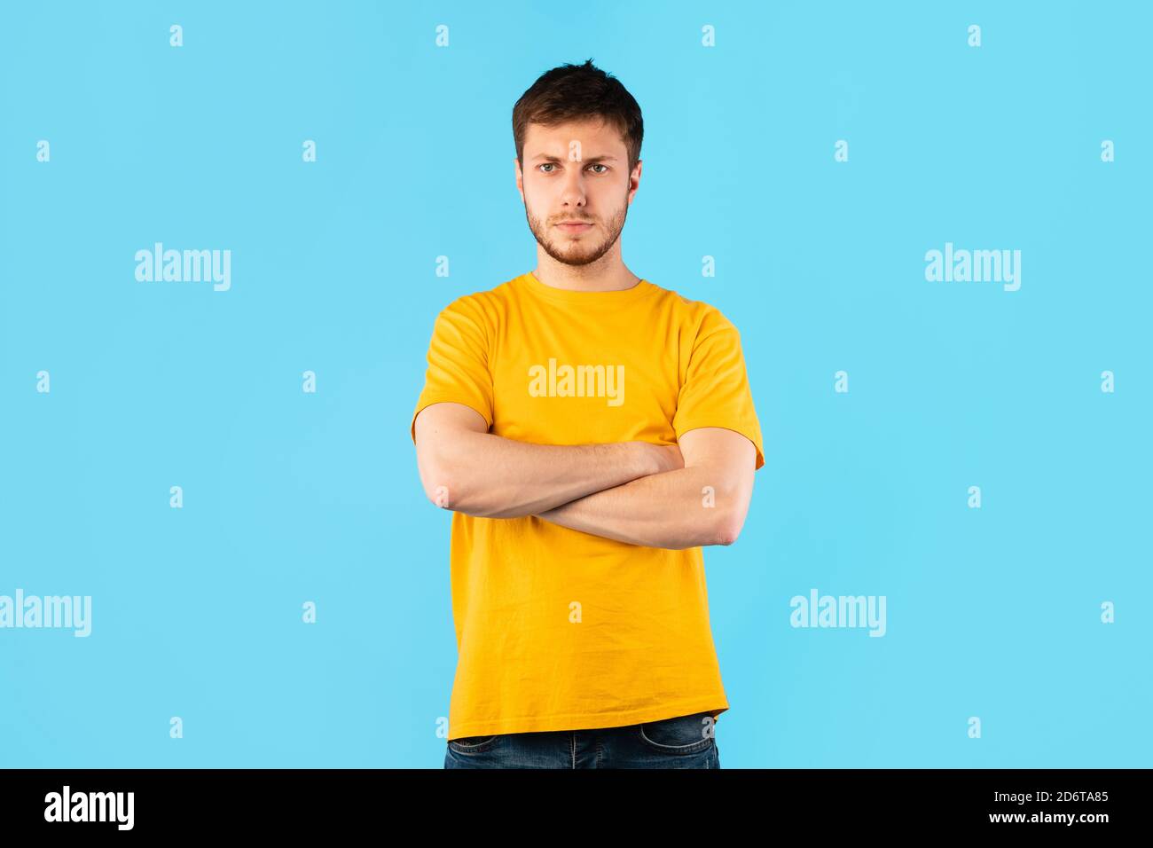 Portrait of offended man standing with folded arms Stock Photo - Alamy