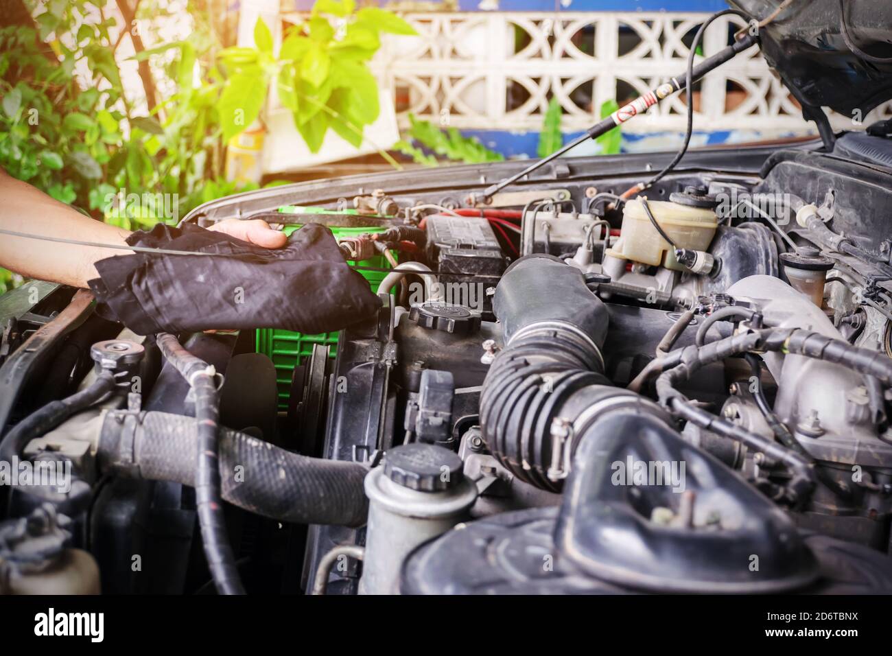 Cars mechanic is checking the level of engine oil from the engine oil ...