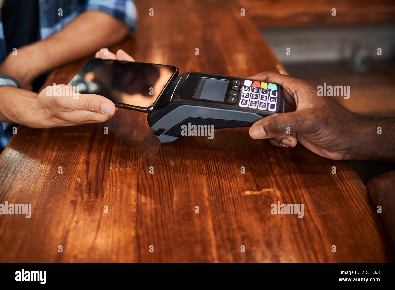 Male customer using mobile phone for contactless payment Stock Photo ...