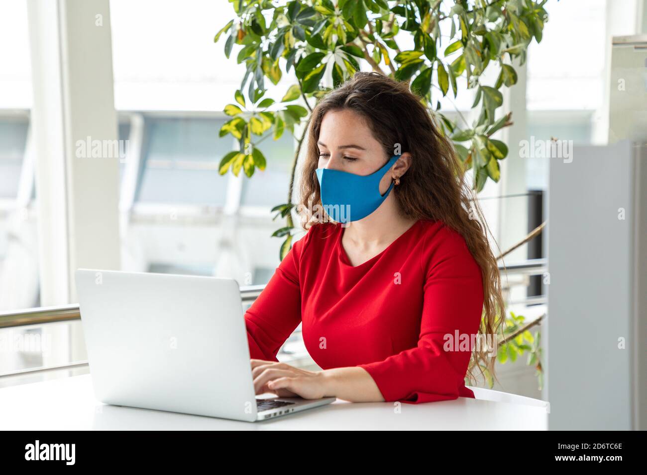 Lady in safety mask typing hi-res stock photography and images - Alamy