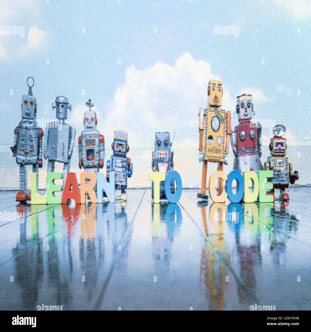 LEARN TO CODE wooden letters and retro robot toys on a wooden floor ...