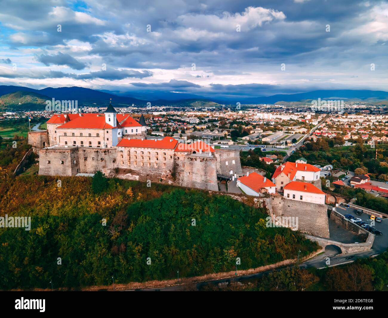 Aerial view of medieval castle on mountain in small european city in ...