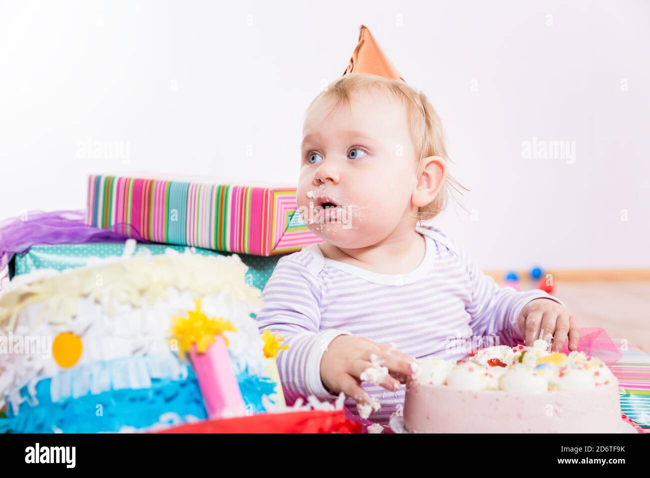 Toddler eating birthday cake Stock Photo - Alamy