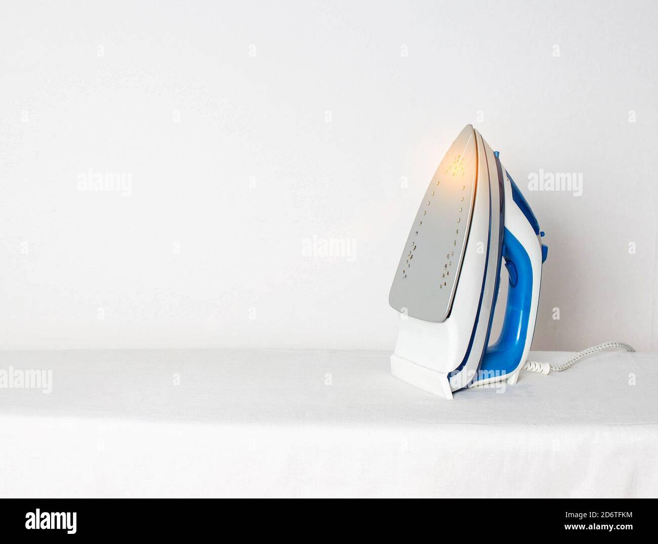 A modern iron with an aluminum sole for smoothing the folds of clothes ...