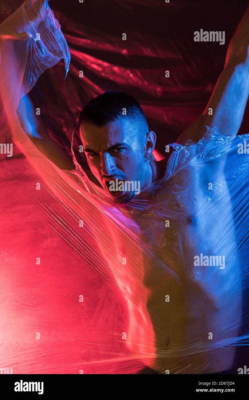 Aggressive male in casual clothing shouting and looking at camera while ...