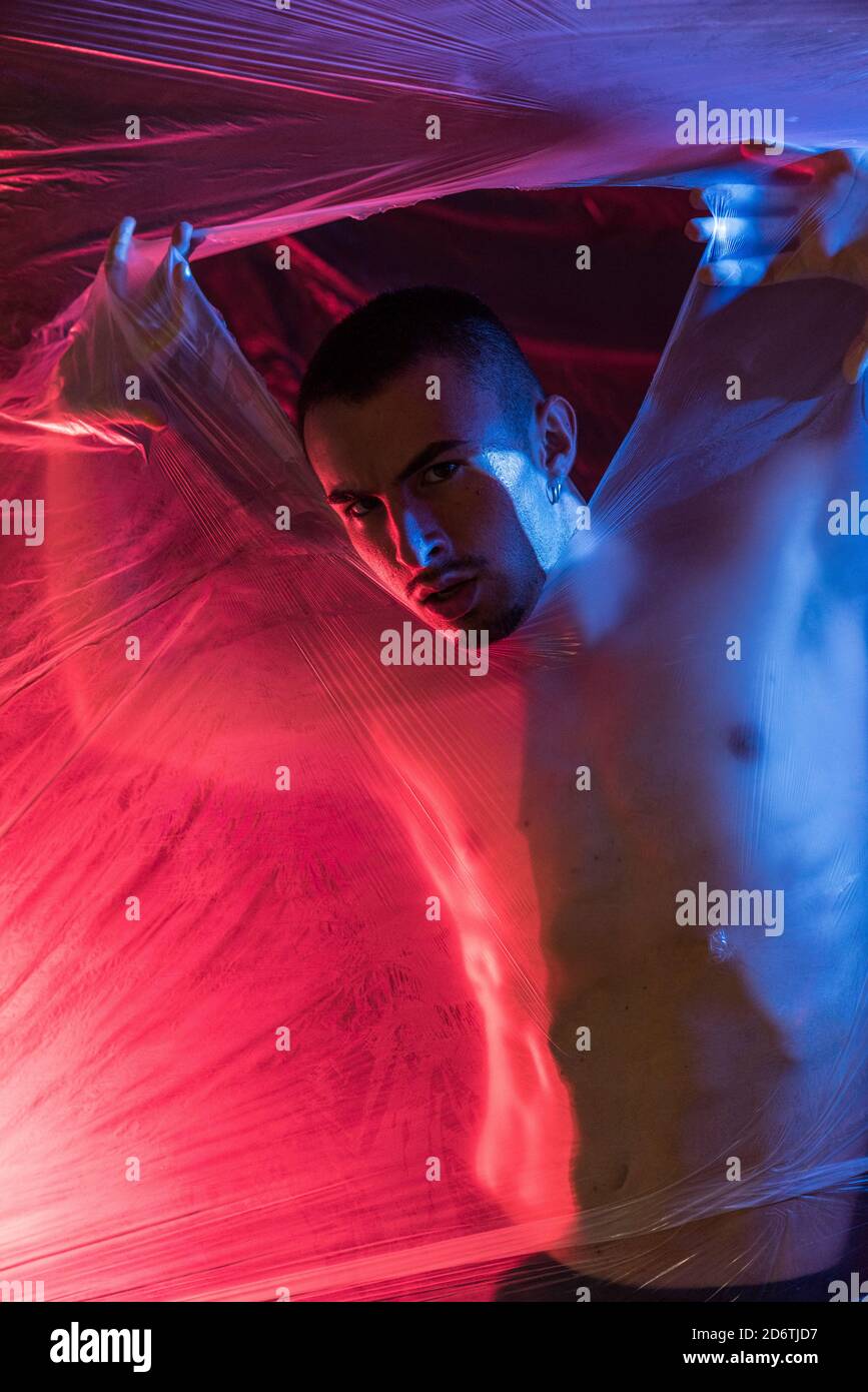 Aggressive male in casual clothing shouting and looking at camera while ...