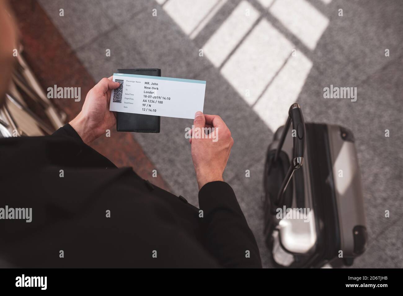 Close up picture of a man holding plane ticket in his hands Stock Photo ...
