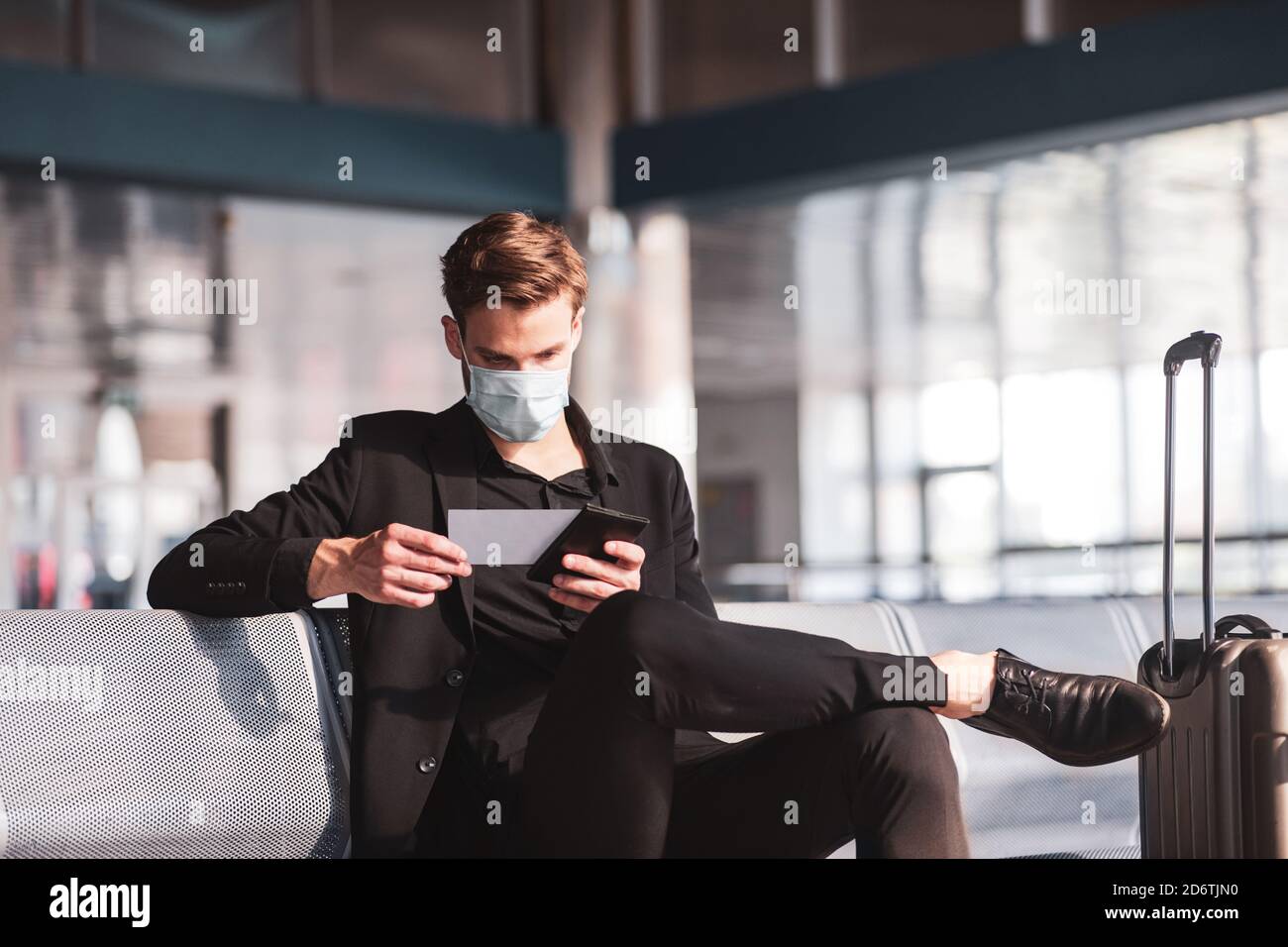 Man checking his ticket before the departure Stock Photo - Alamy