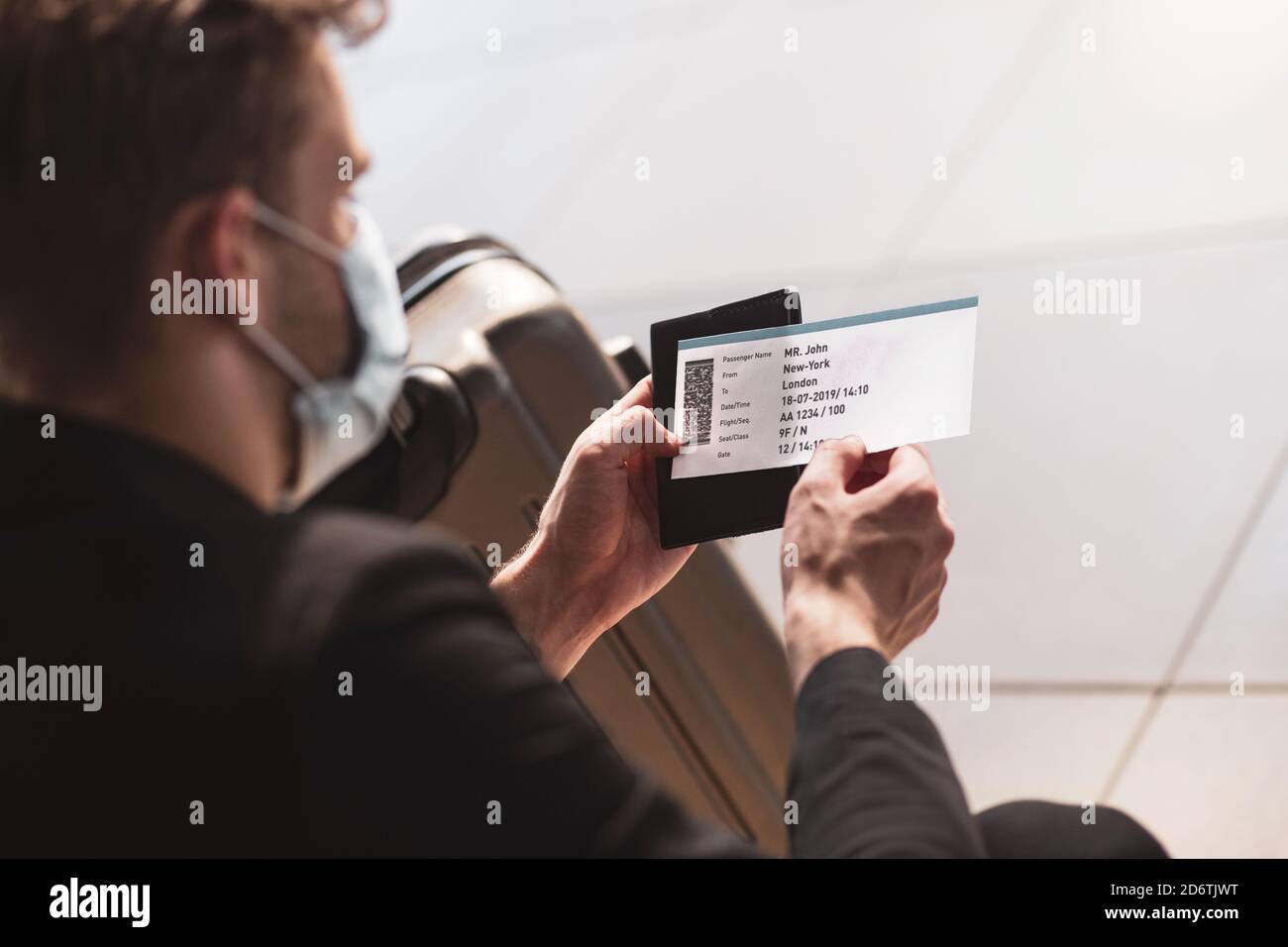 Man reading information in his boarding pass Stock Photo - Alamy