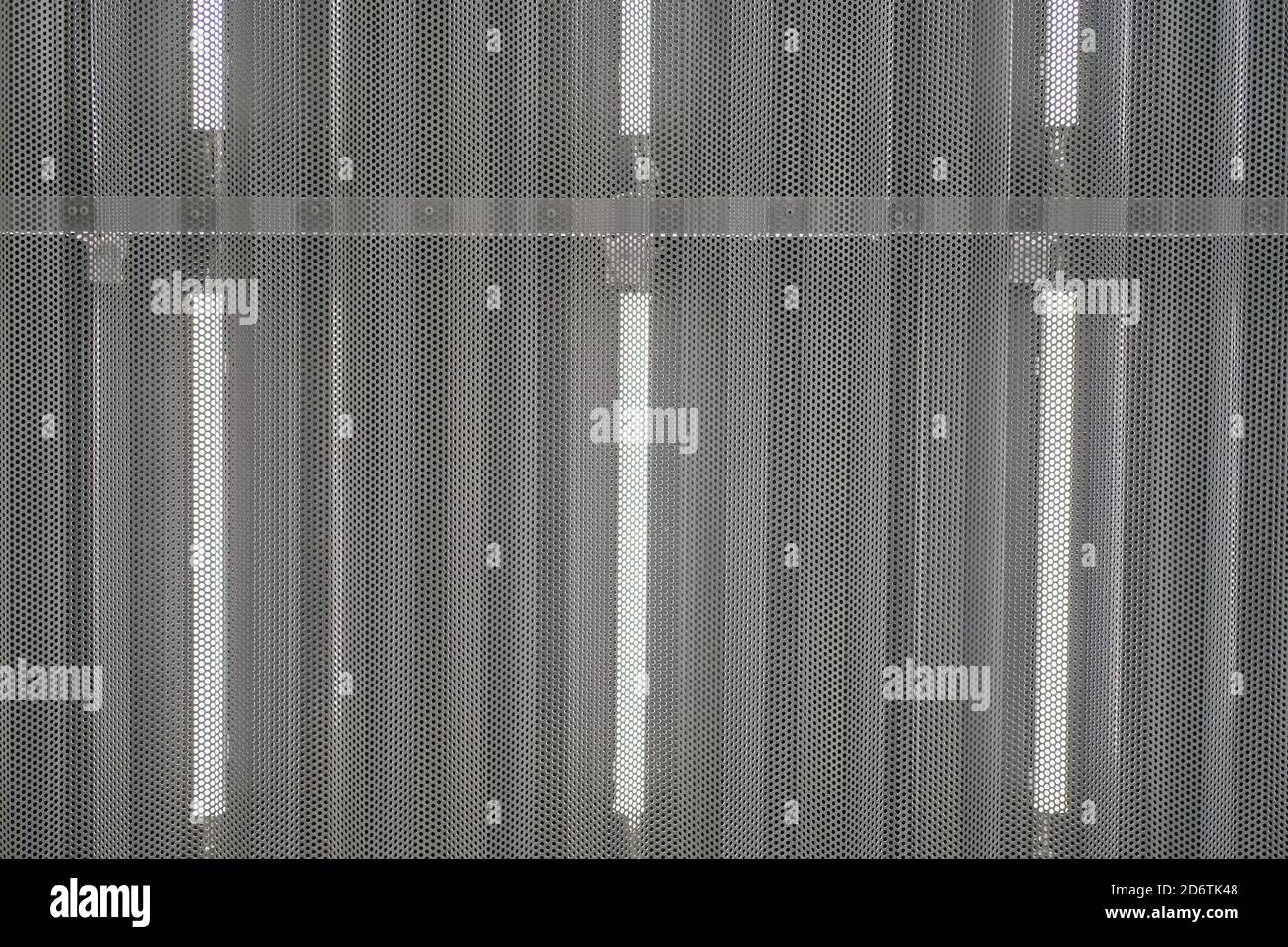 Texture of decorative grid with round holes and lighting lamps on the ...