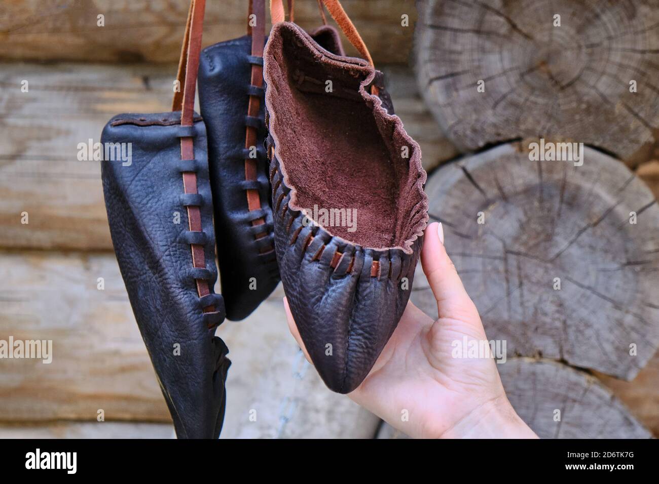 Female hand holding retro shoes leather. Retro style black shoes made ...