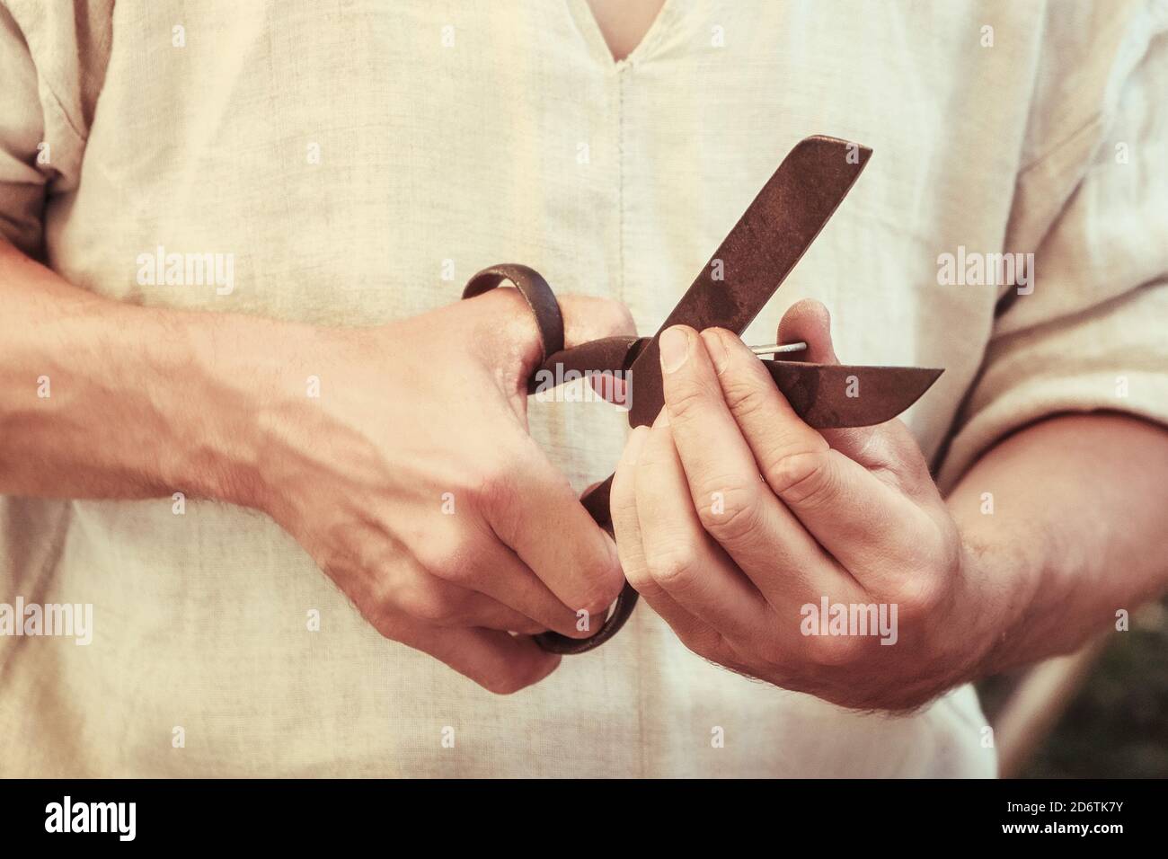 Hand holding big scissors making hi-res stock photography and images ...