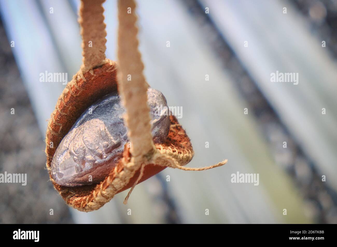 Roman slingshot of leather on the background of chain mail. Vintage ...