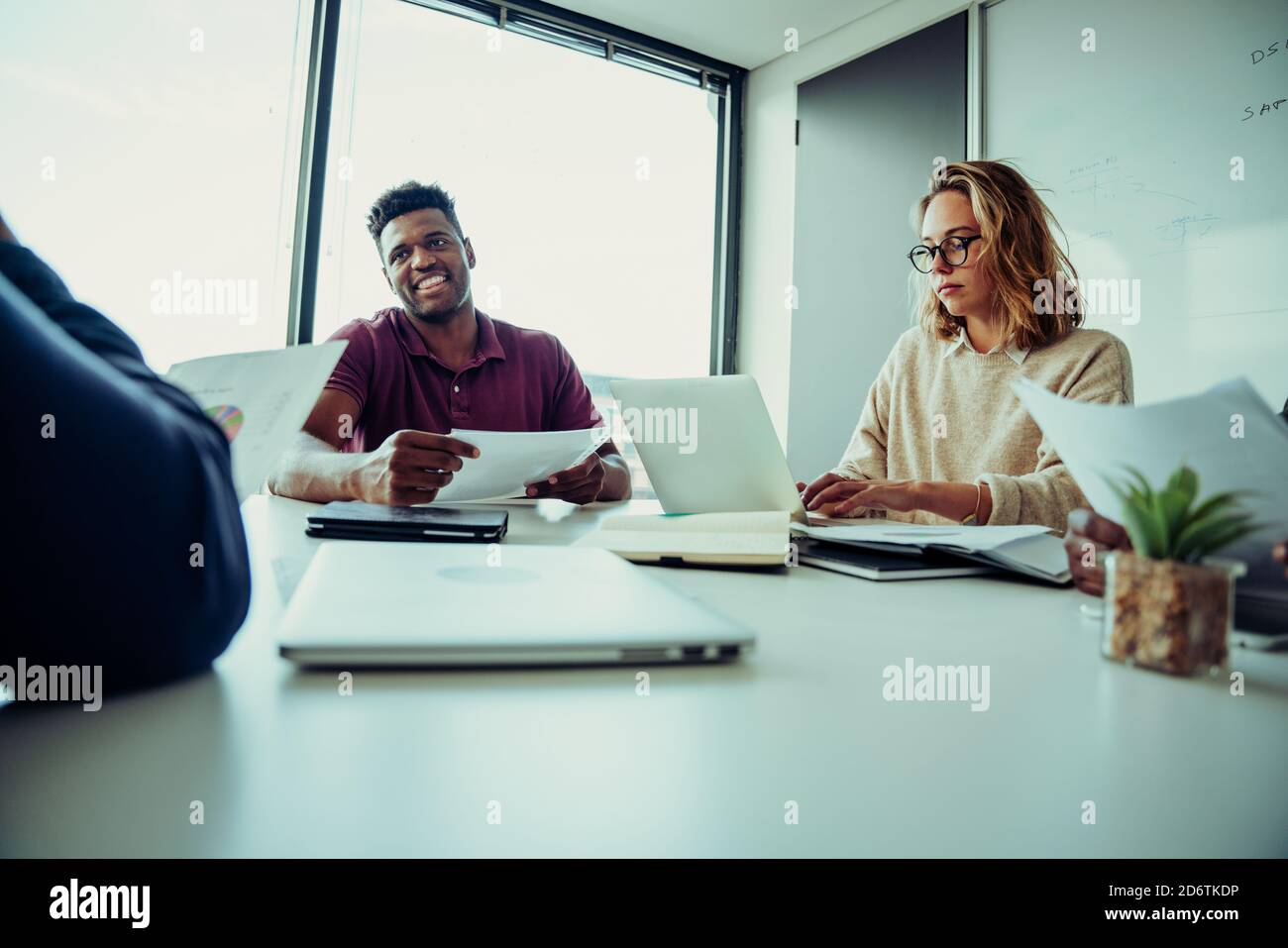 Male and female business partners discussing improvements of new ...