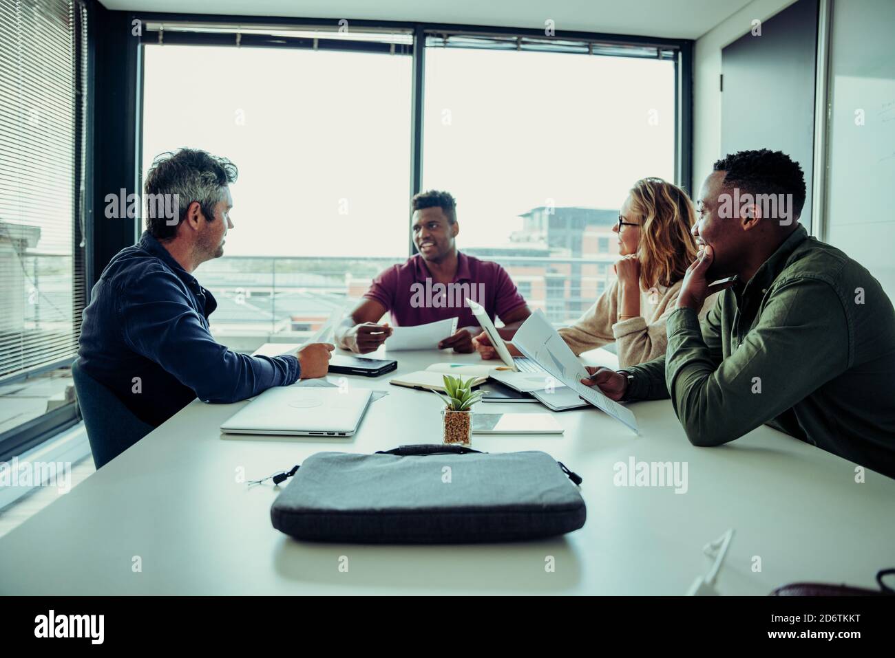 Caucasian male boss briefing team on goals for start up of new business ...