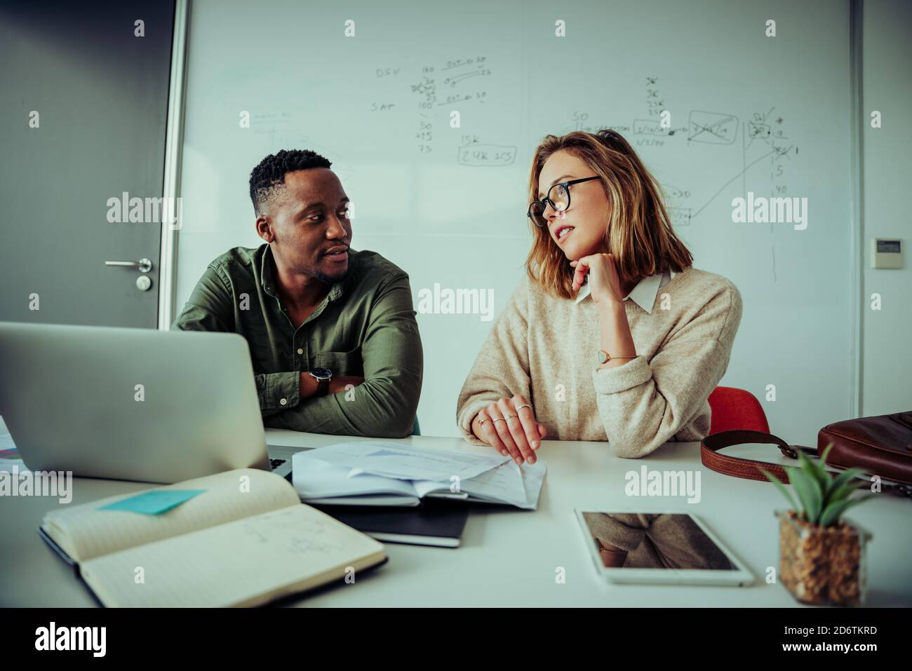 Male and female partners brainstorming ideas for new business ...