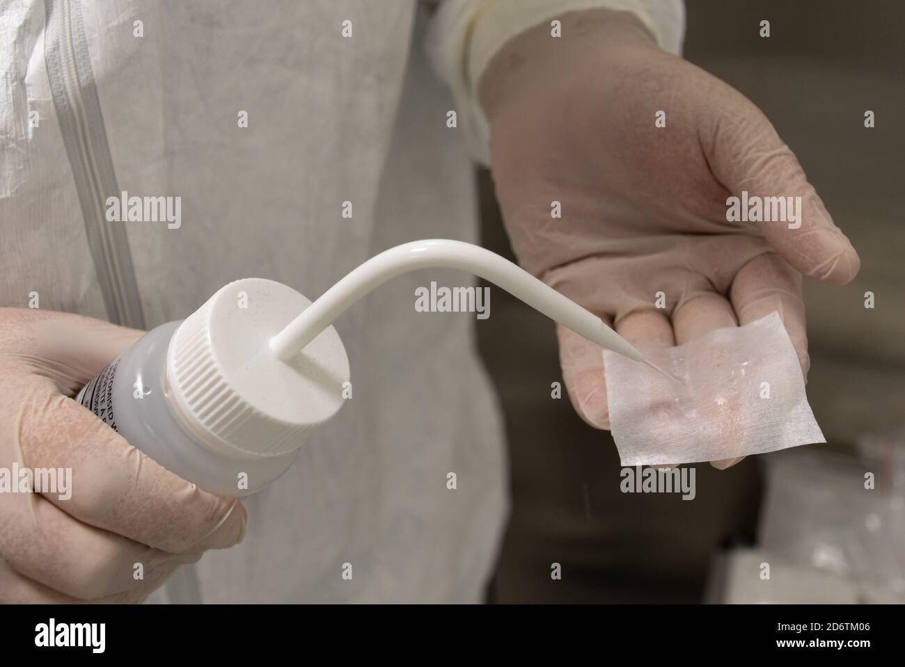 Doctor or nurse cleaning and disinfecting tools with gloves and ...