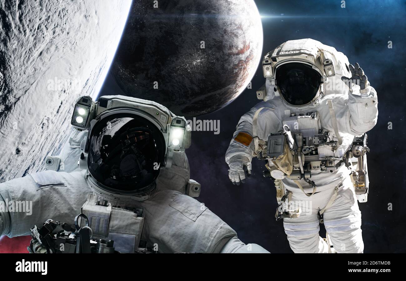 Astronauts in outer space against background of inhabited planets Stock ...
