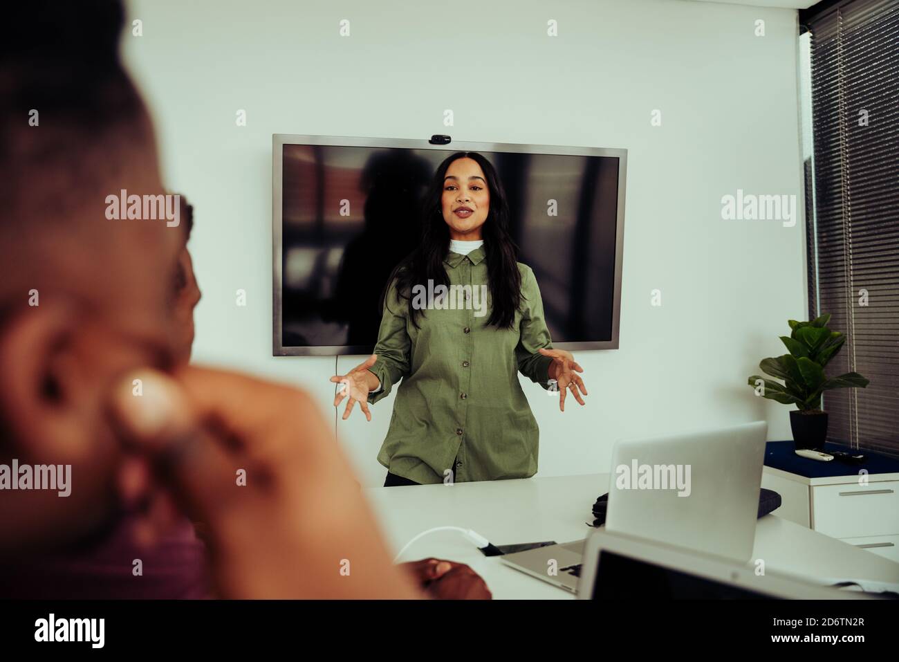 Business woman using hand gestures while presenting ideas to clients ...