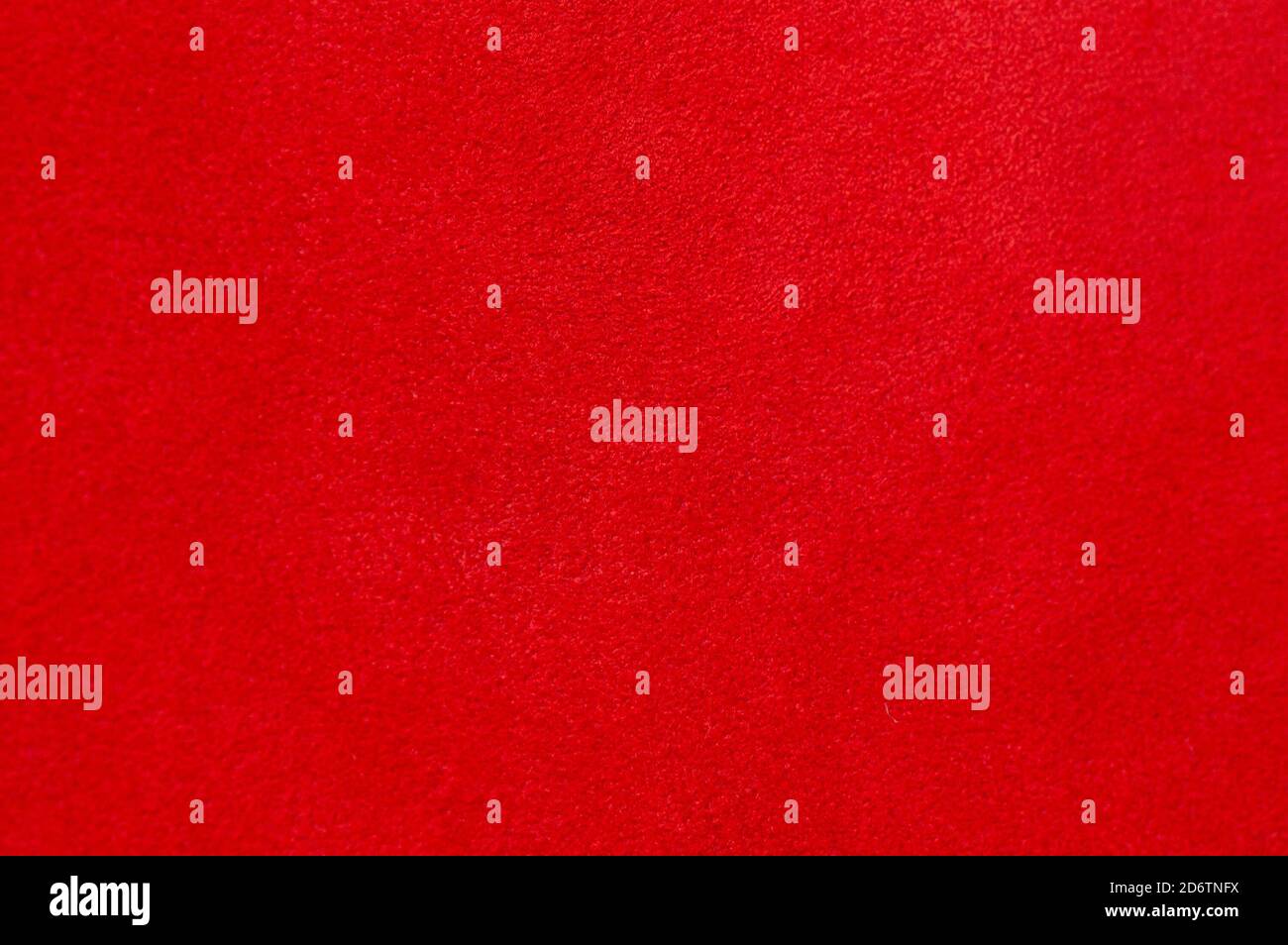 red matte background of suede fabric, closeup. Velvet texture of ...