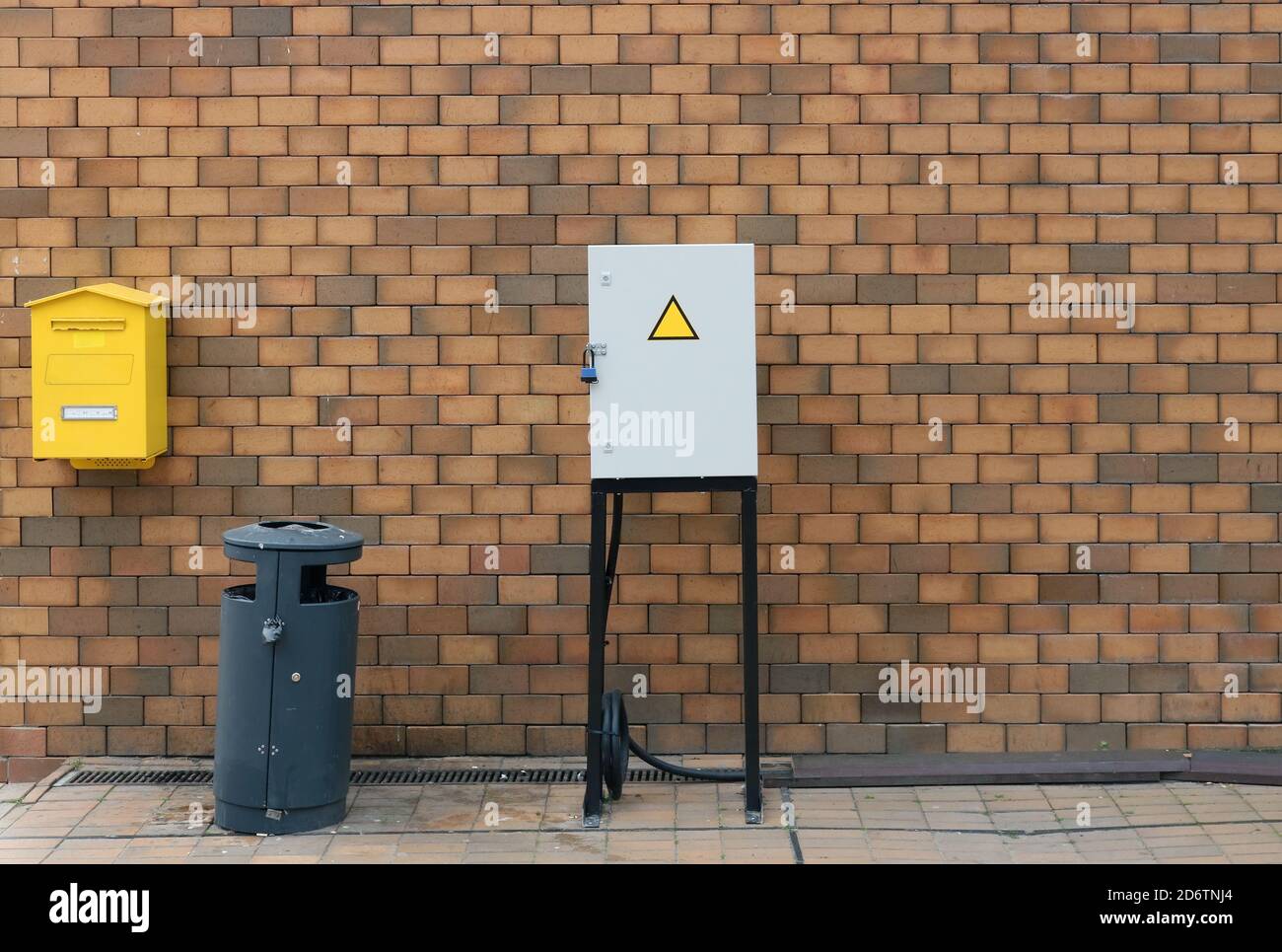 Brick wall with mailbox, trash can and electric box Stock Photo - Alamy