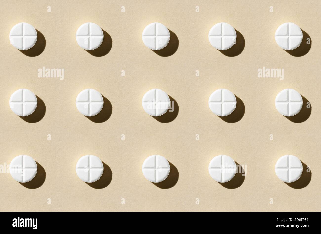 Round tablet pill pattern on a beige background. Hard shadows Stock ...