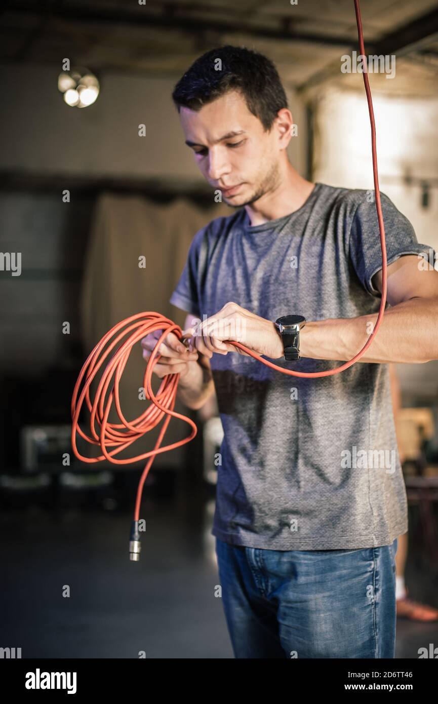 Behind the scene. Sound engineer is connecting the audio cables in the ...