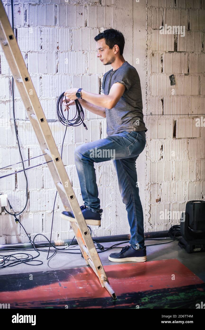 Behind the scene. Sound engineer is connecting the audio cables in the ...