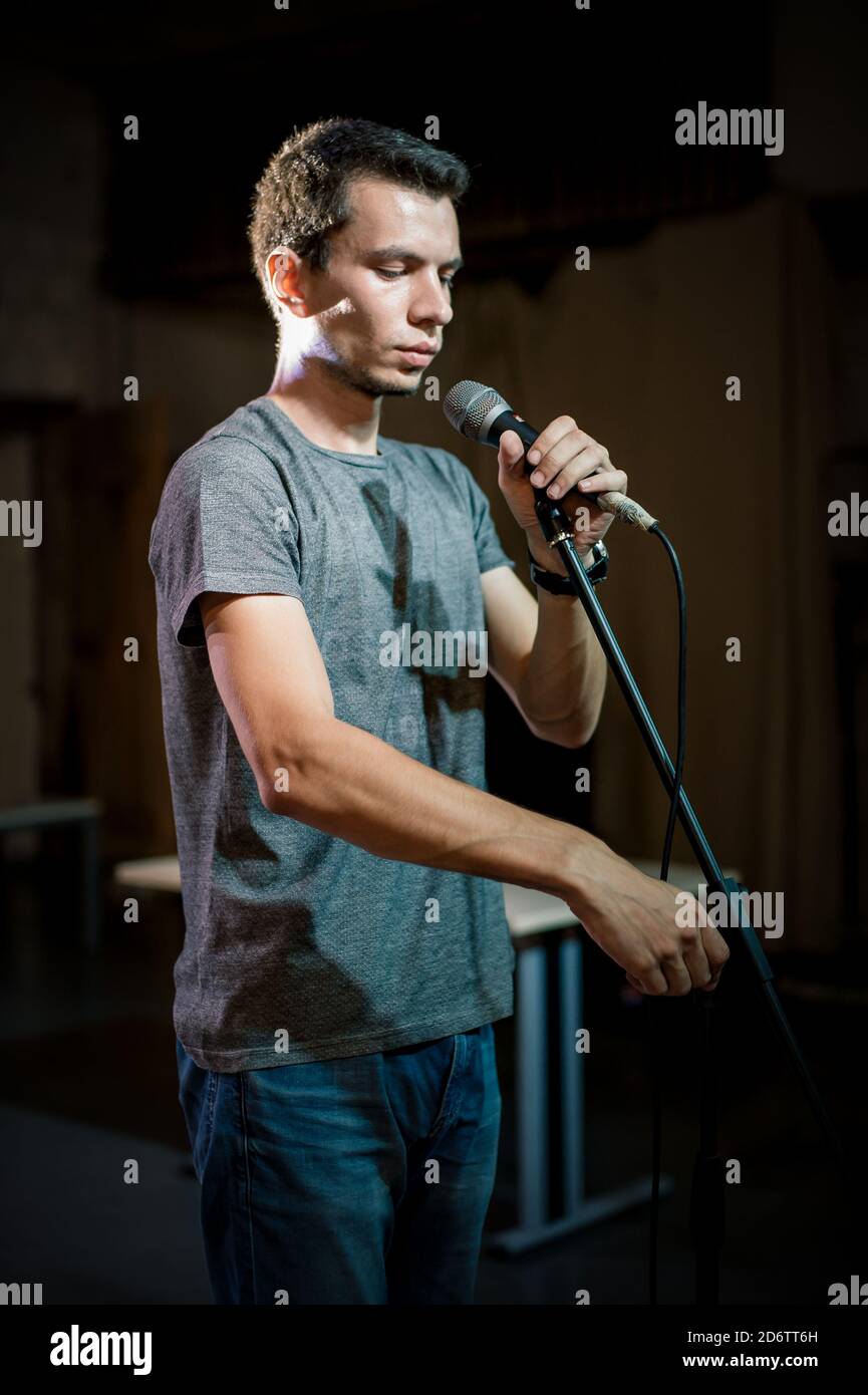Theater audio technician adjusting an microphones on the scene ...
